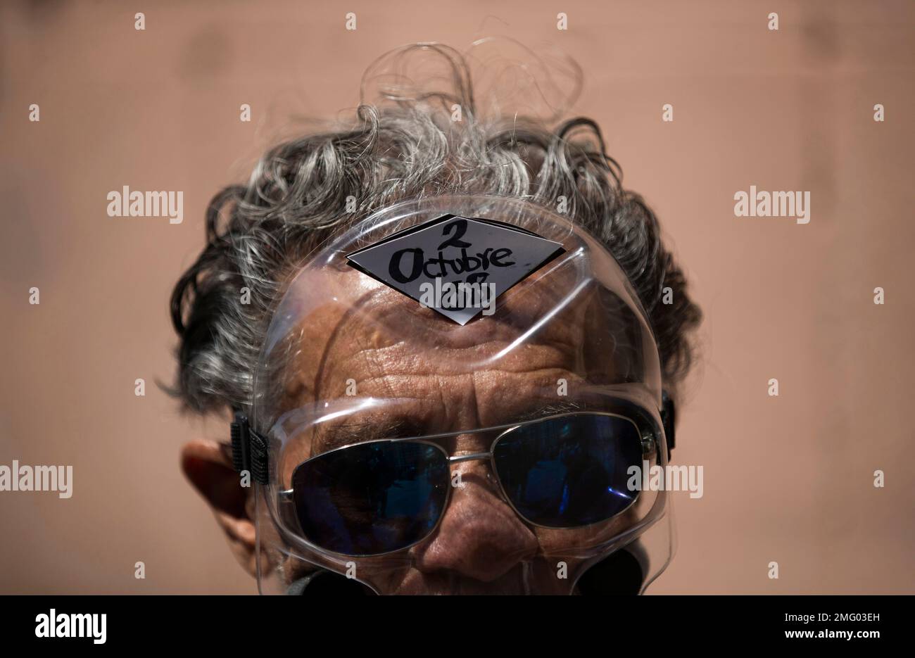 A man wears a face shield with the date "October 2, 1968" during a ...