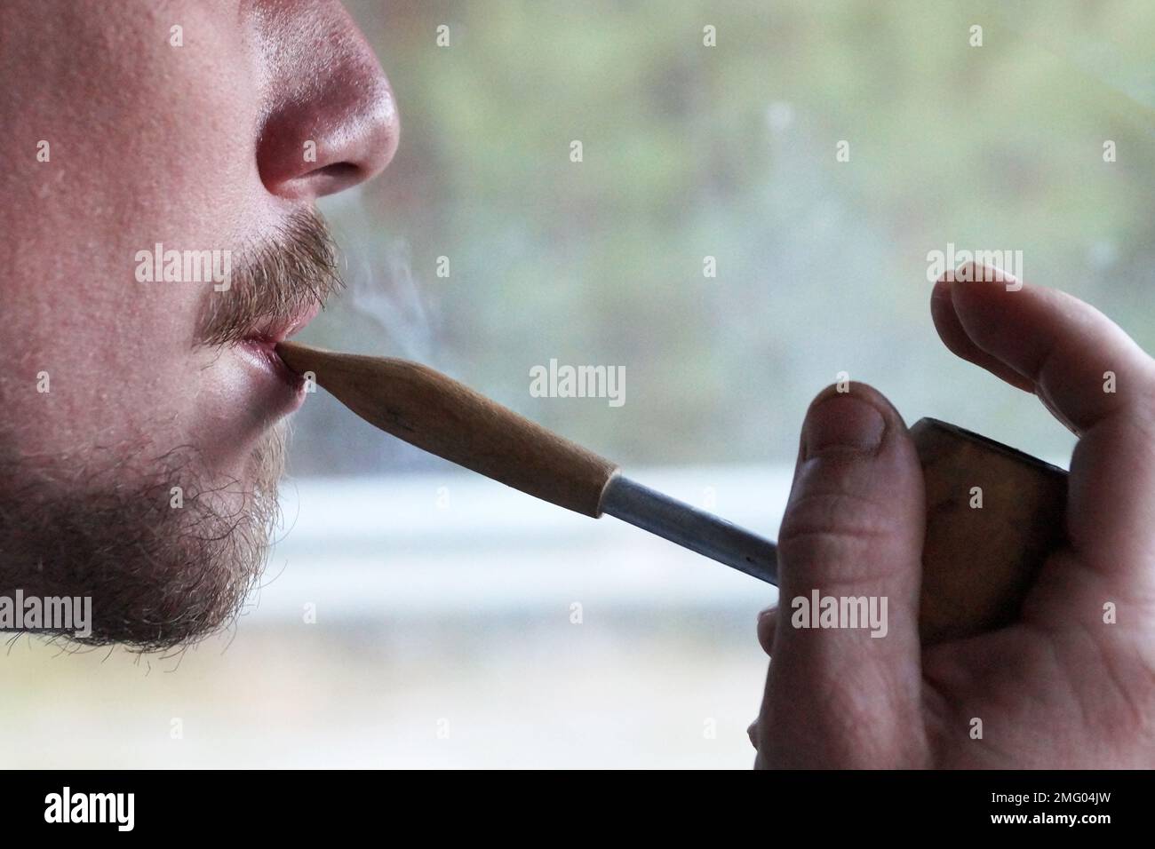 Young man smoking a pipe hi-res stock photography and images - Alamy