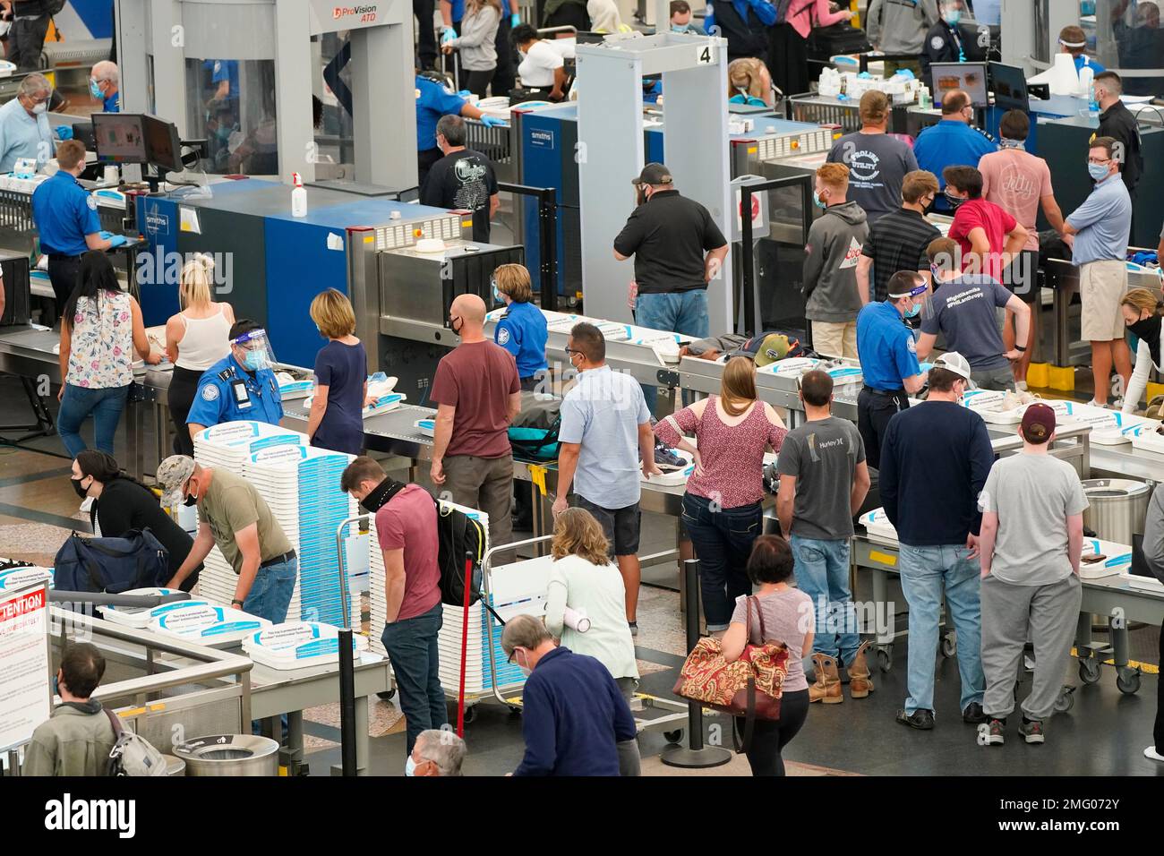 Travellers line up at the south security checkpoint in the main ...