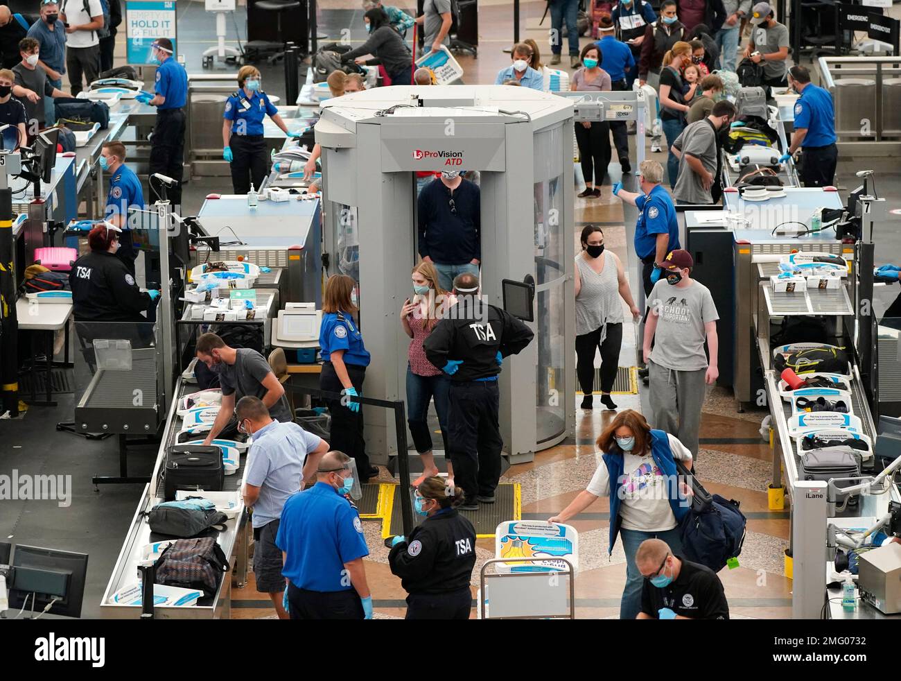 Travellers pass through the south security checkpoint in the main ...