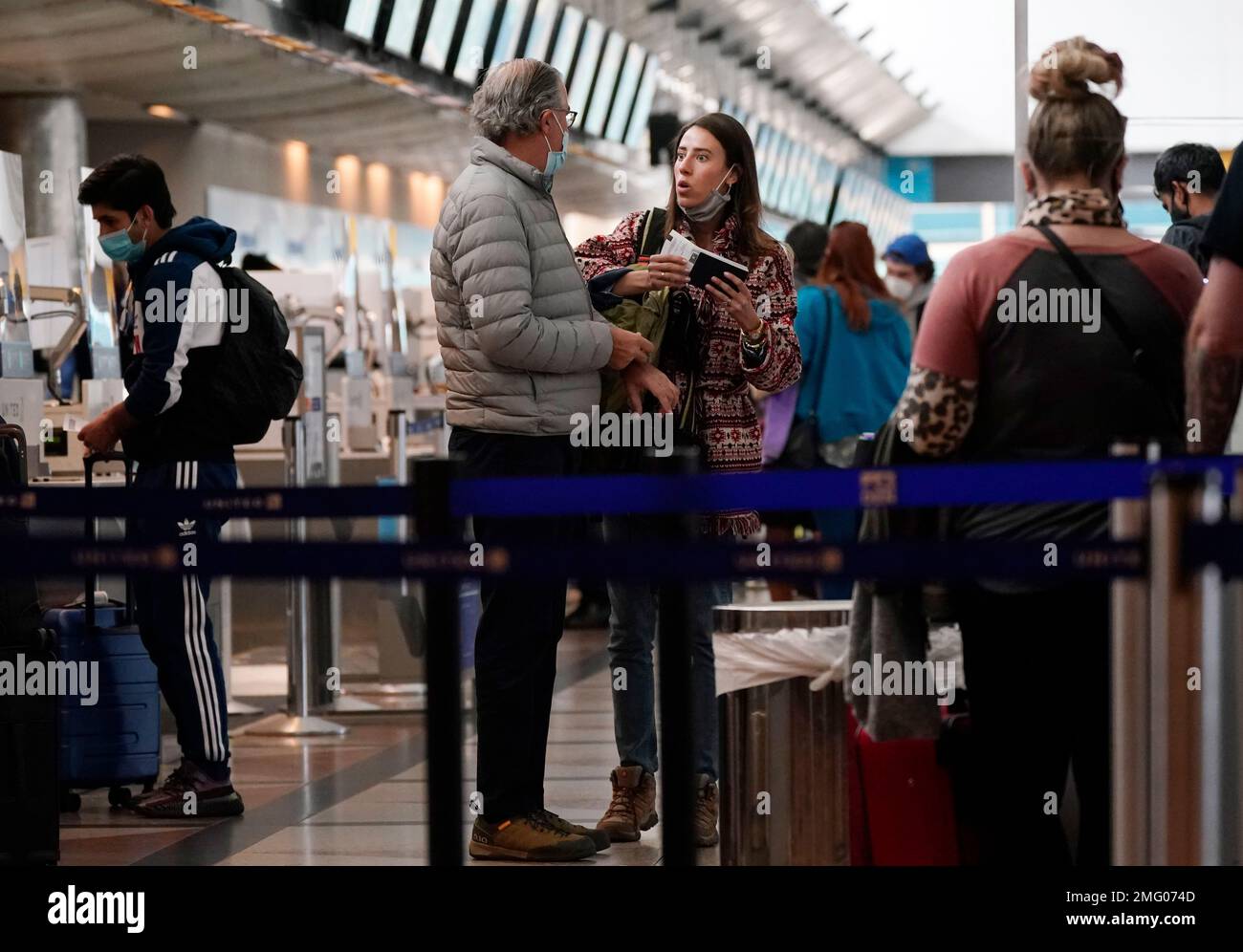 Travellers check in at the United Airlines counter kiosk in the main ...
