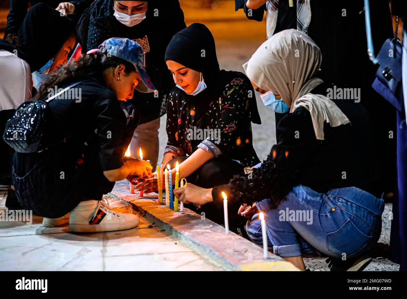 Demonstrators light candles to mark the first anniversary of the anti ...