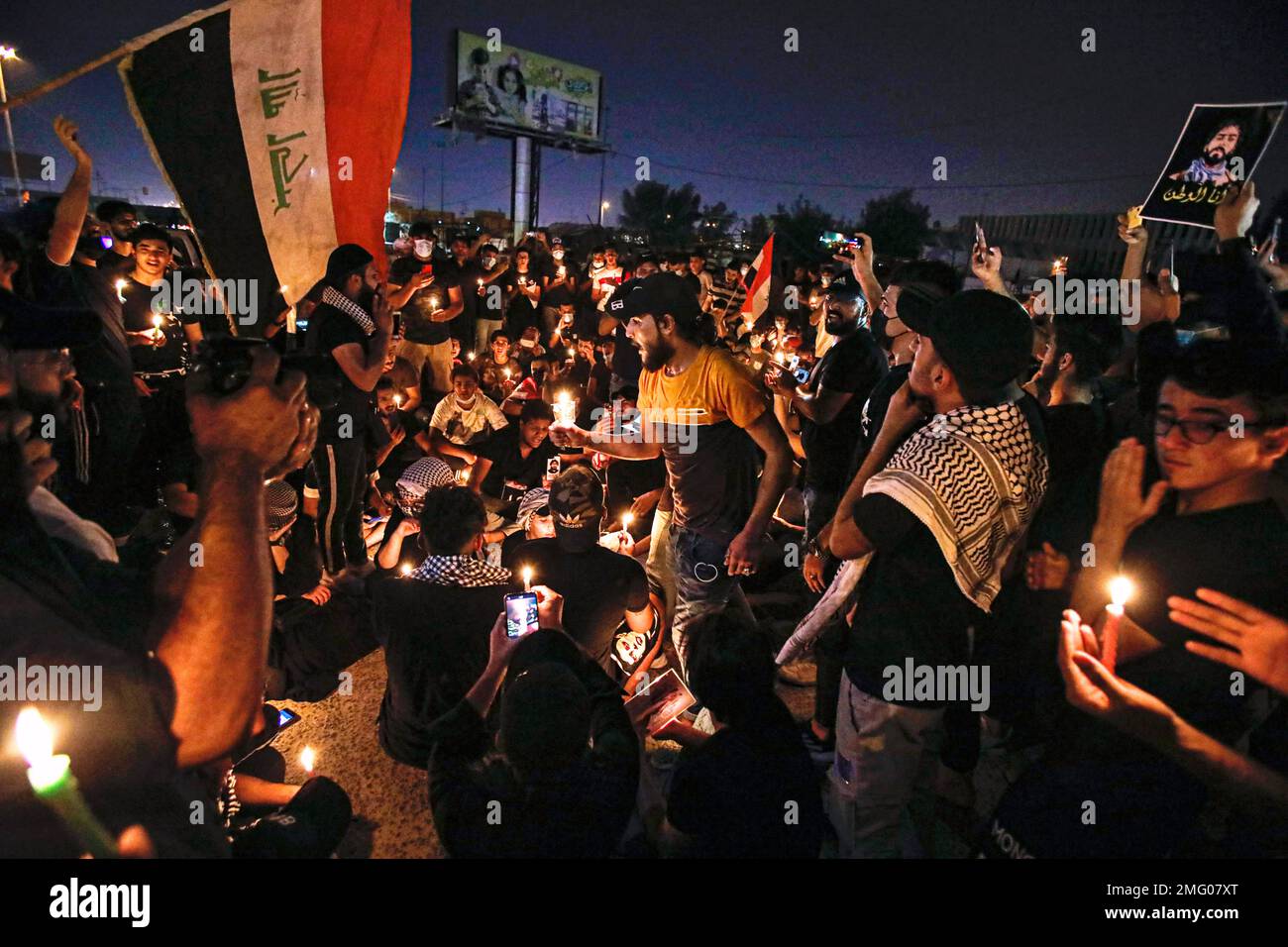 Demonstrators light candles to mark the first anniversary of the anti ...