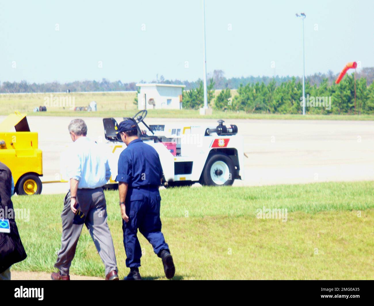 . President Bush holding ATC cap and walking with CAPT David Callahan ...