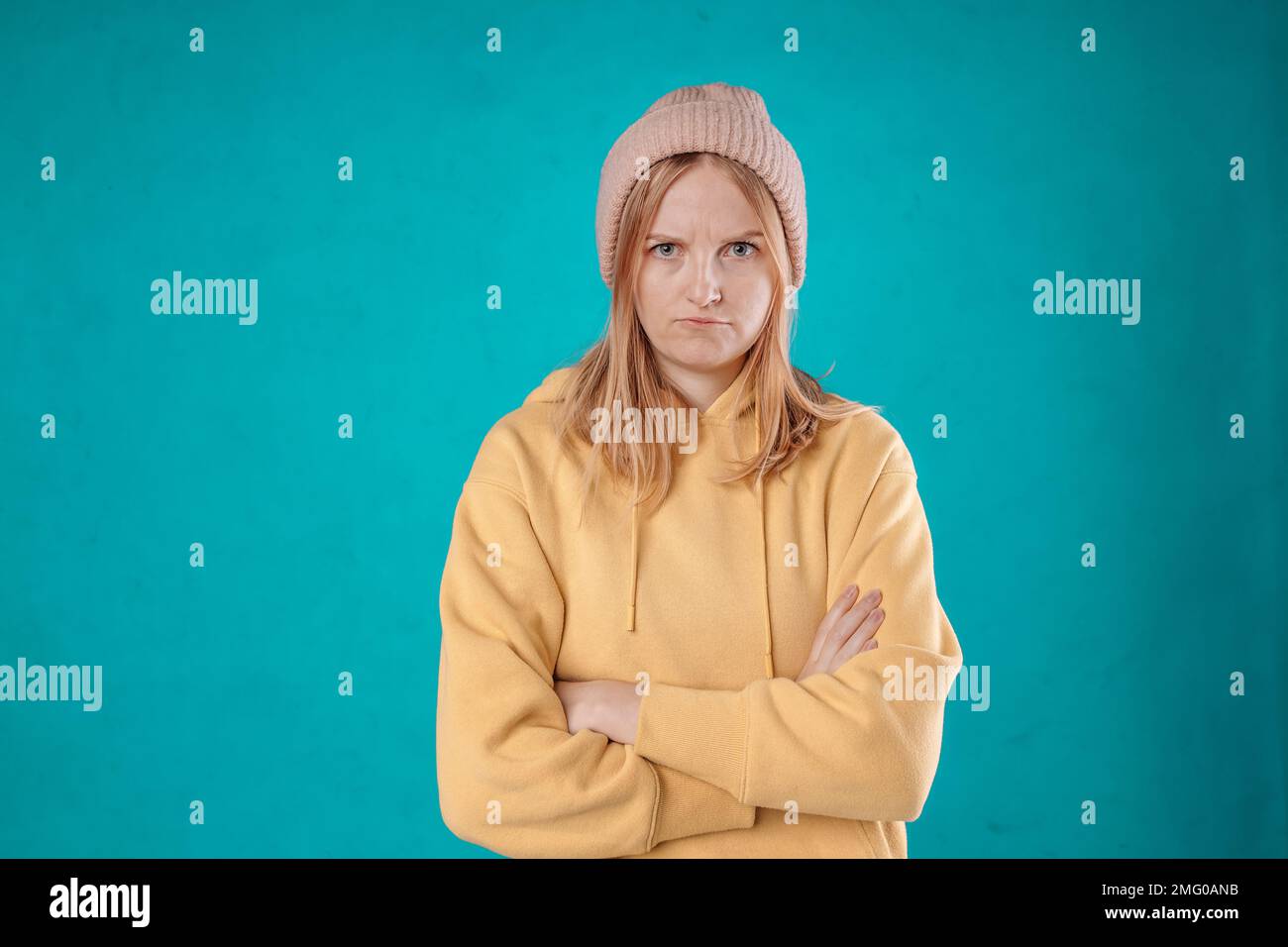 Portrait of an upset young casual girl standing with arms folded ... Portrait of an upset young casual girl standing with arms folded ...