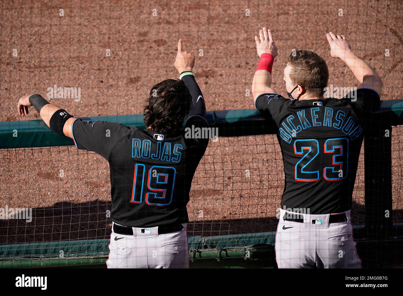 Miami Marlins' Miguel Rojas (19) and Corey Dickerson (23) watch play ...