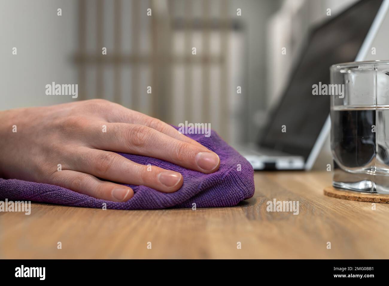 Hand cleaning office, home desk from dust. Workplace hygiene concept ...