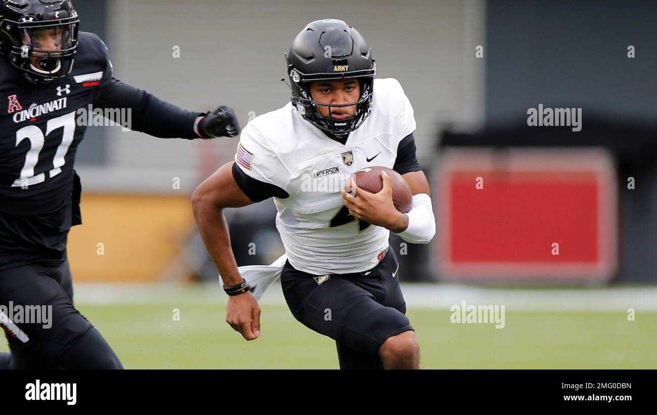 Army quarterback Christian Anderson, right, cuts up field past ...