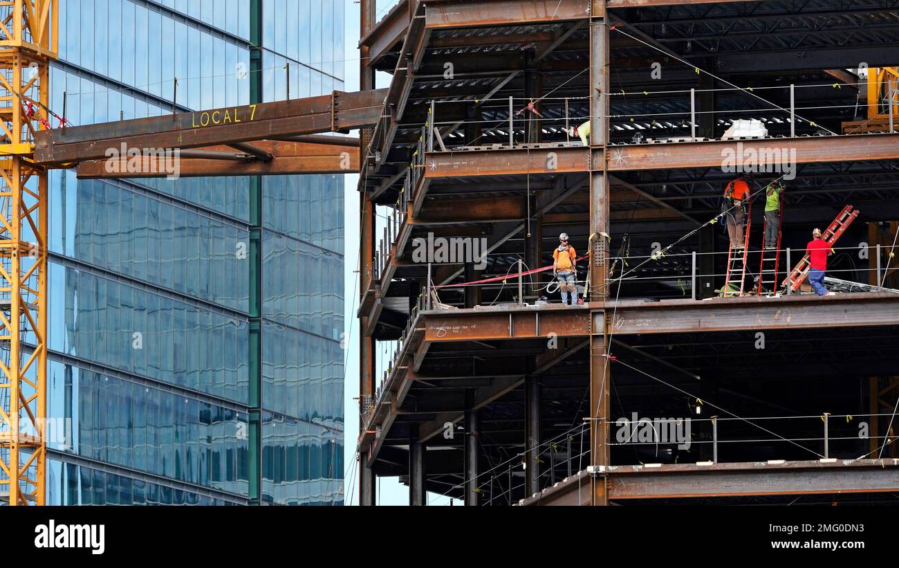 Construction tradesmen work on a building project in the Seaport ...