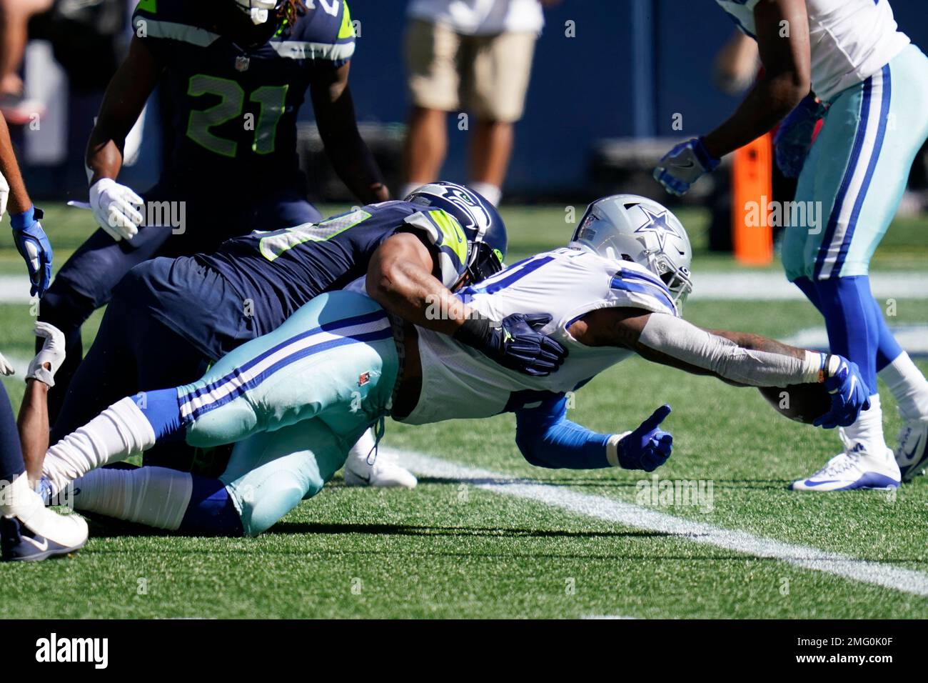 Dallas Cowboys running back Ezekiel Elliott reaches, but is stopped on ...