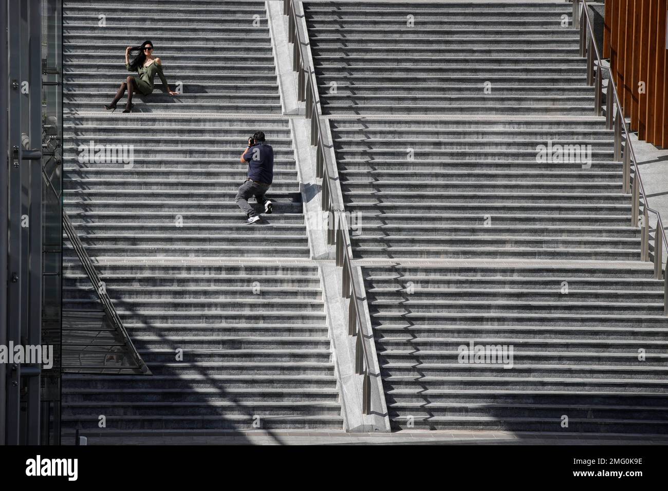 A model poses for a shooting with a photographer at the Porta Nuova ...