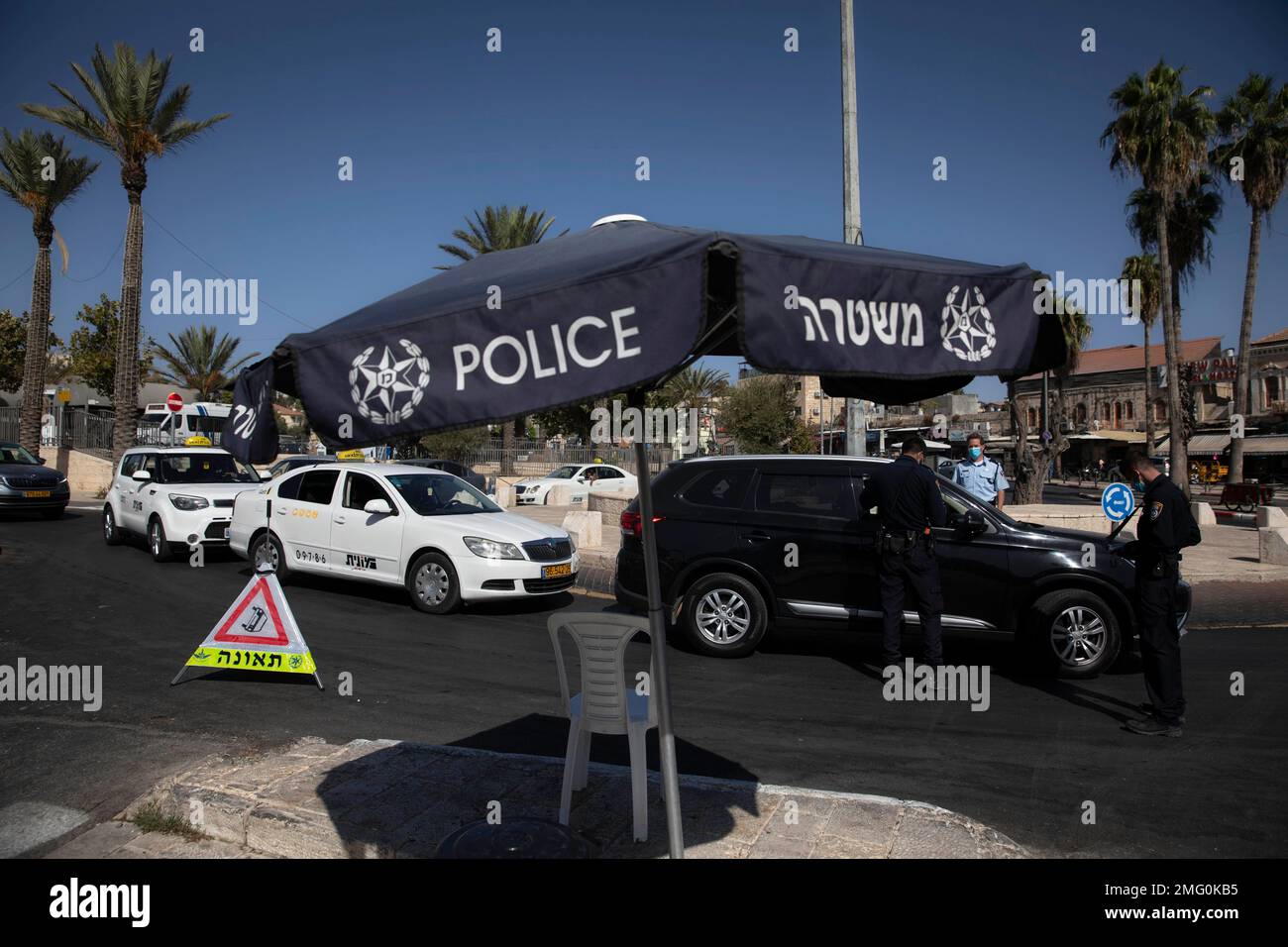 Israeli police officers check cars during the current nationwide ...