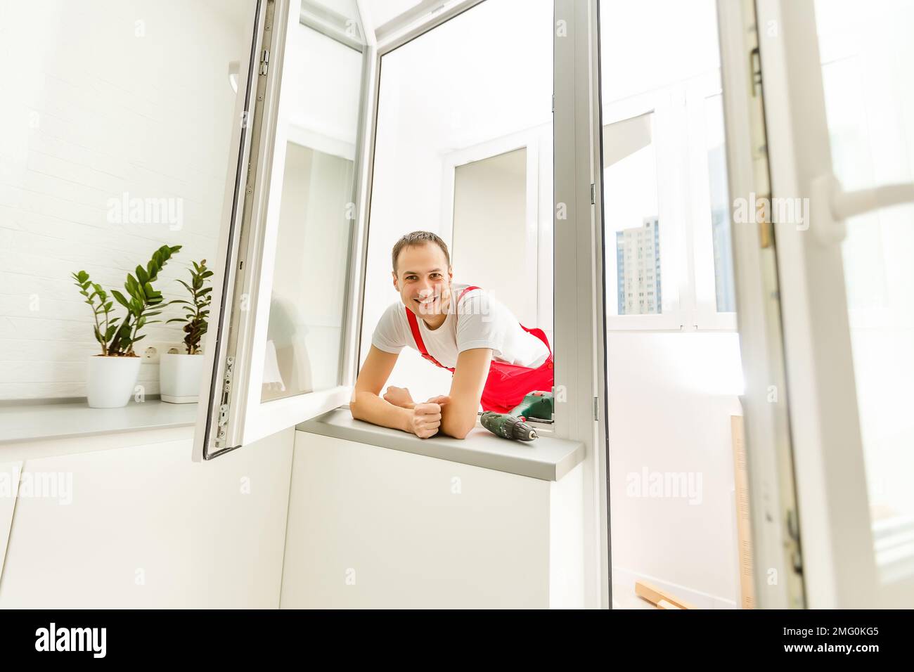 Construction worker installing window in house Stock Photo - Alamy
