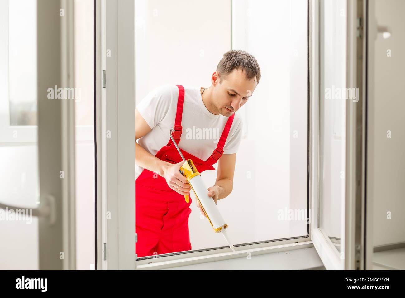 Carpenter repairing window frames, home is being updated to be sold ...