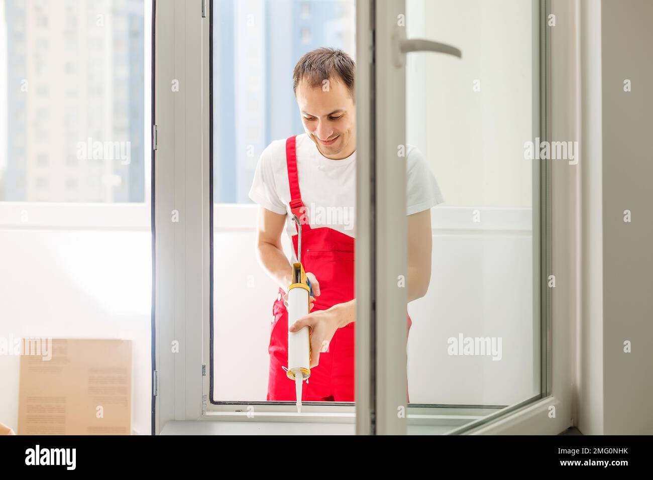 Construction worker installing window in house Stock Photo - Alamy