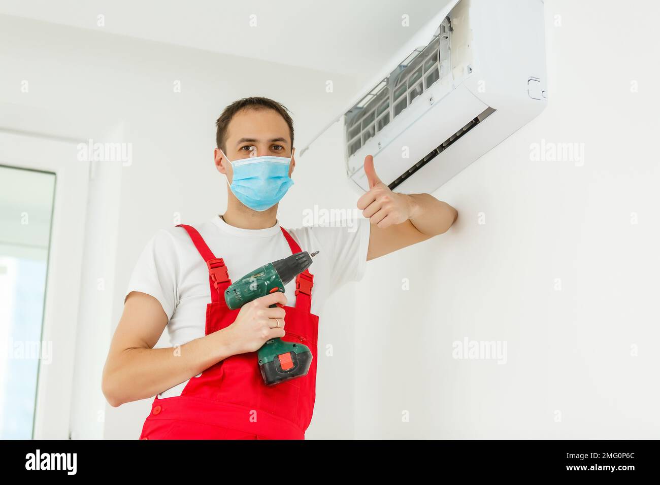 Happy Male Technician Repairing Air Conditioner With Screwdriver Stock ...