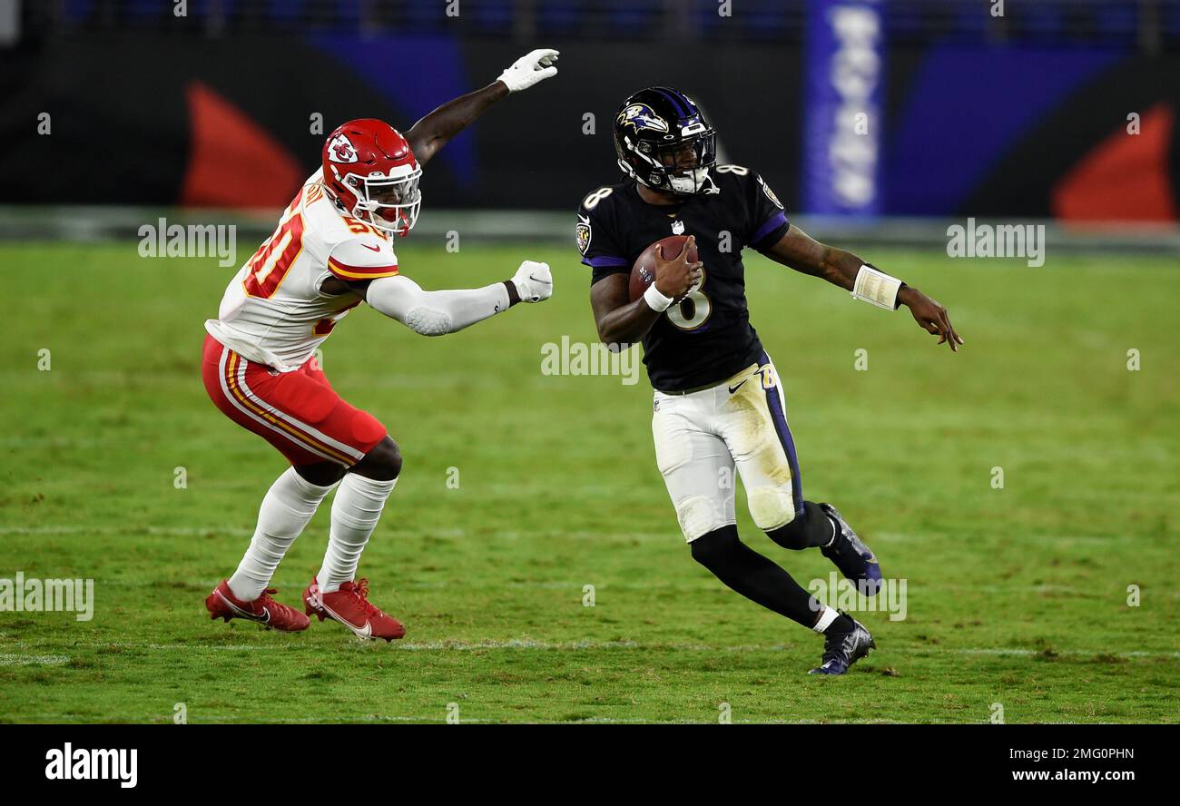Baltimore Ravens quarterback Lamar Jackson (8) scrambles away from ...
