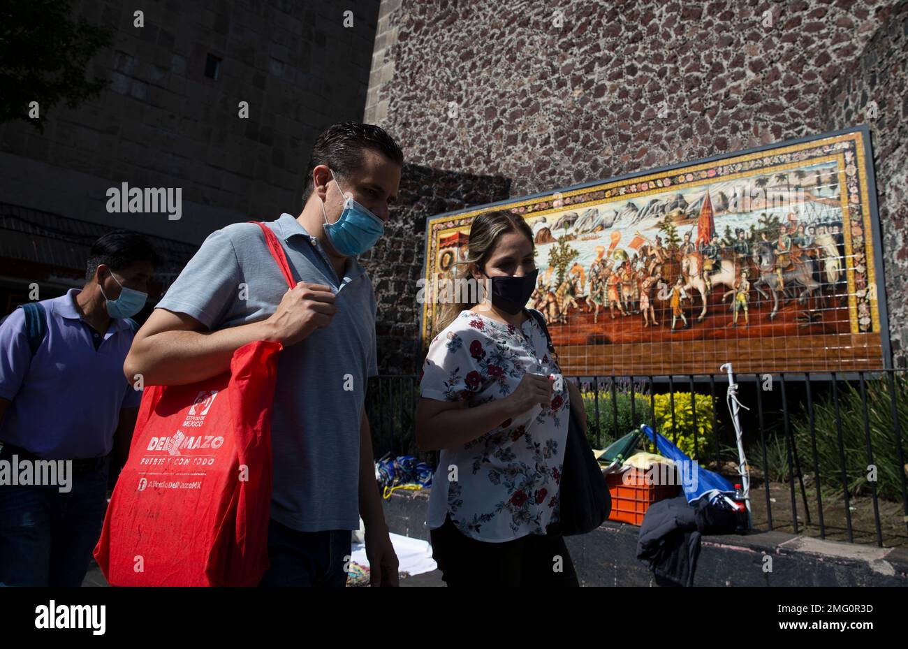 Locals walk past a mural dedicated to Spanish Conquistador Hernan ...