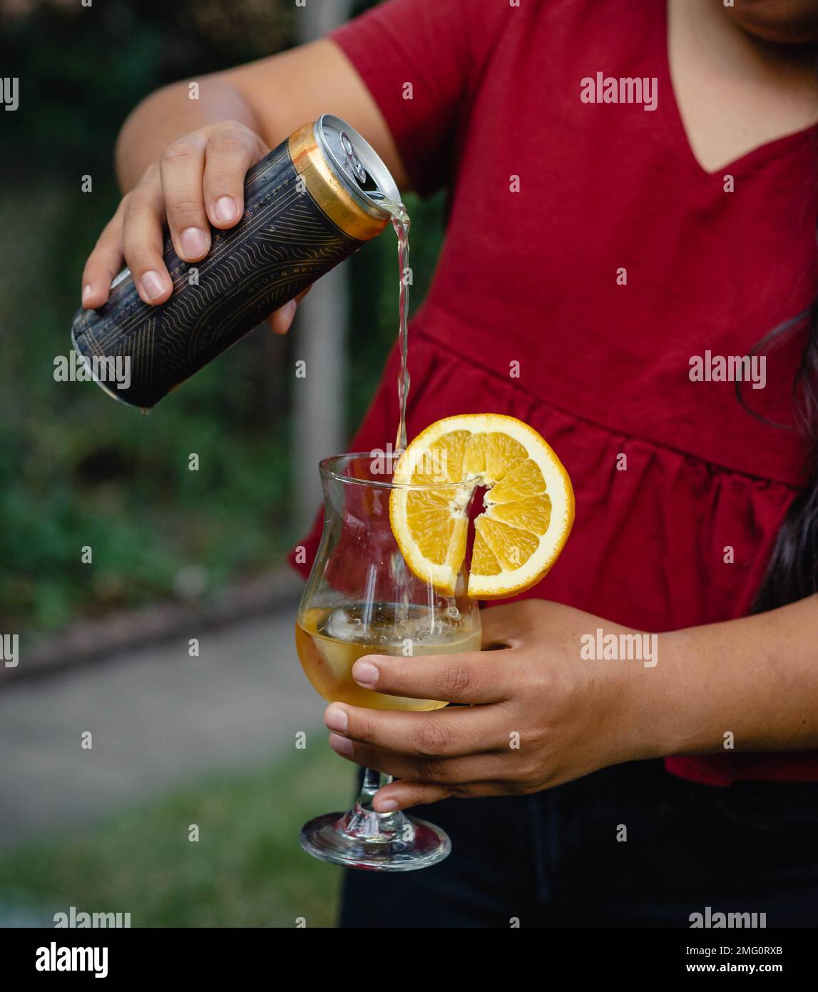 Female bartender pours soda into cocktail while outside Stock Photo - Alamy