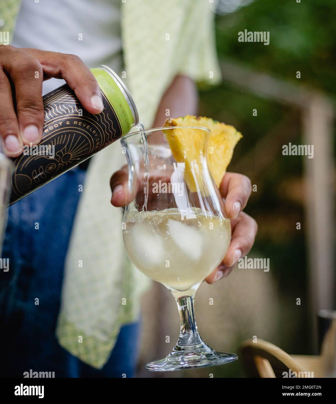 Male bartender pours soda into cocktail while outside Stock Photo - Alamy
