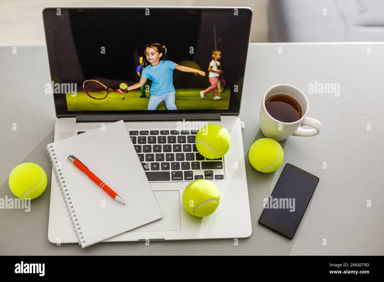 Sports tennis player with racket in blue costume. Woman atlete. Laptop ...