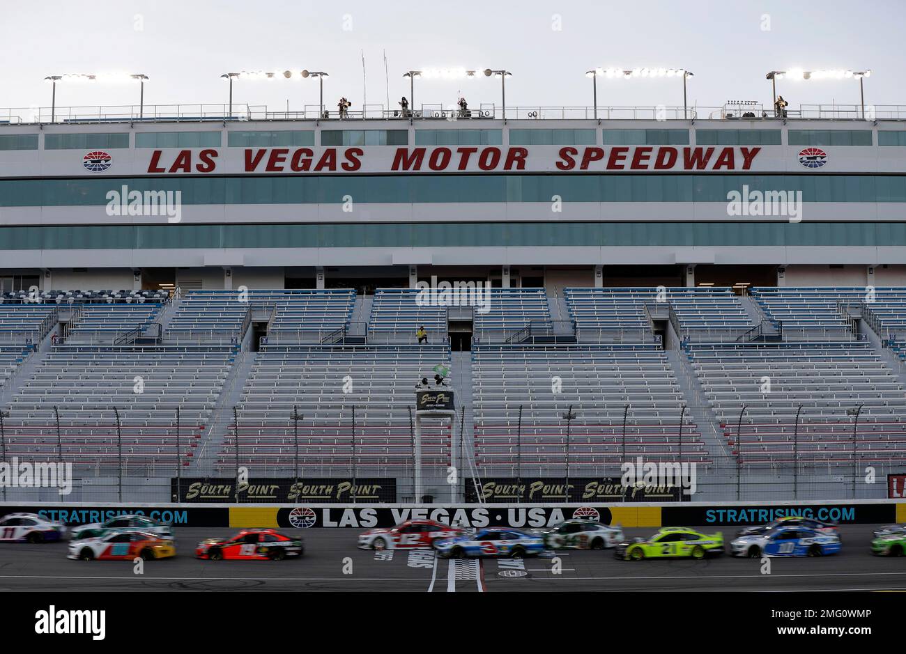 Drivers pass the start finish line during a NASCAR Cup Series auto race ...