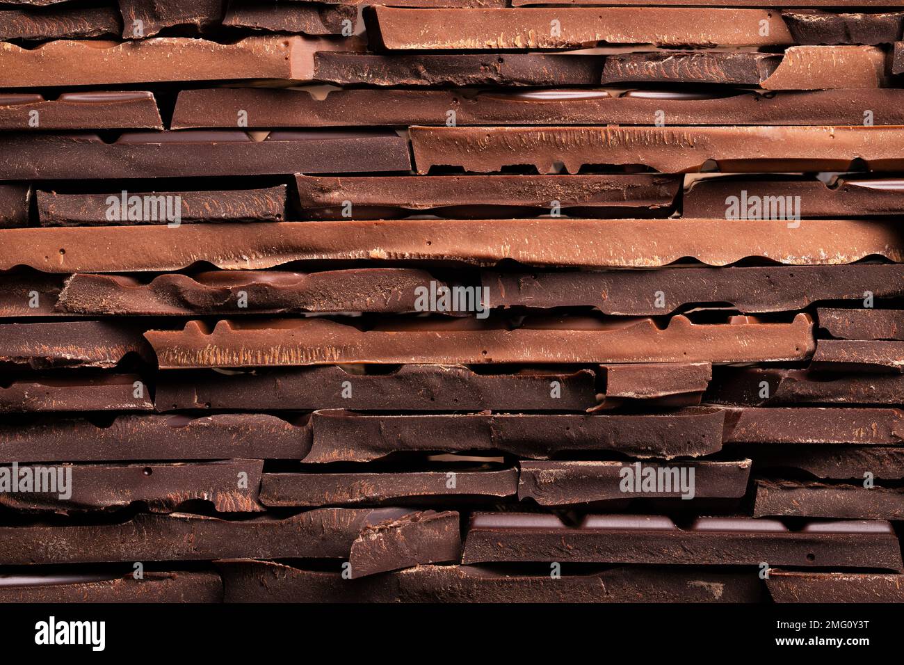 stack of broken chocolate bars, sweet background Stock Photo - Alamy