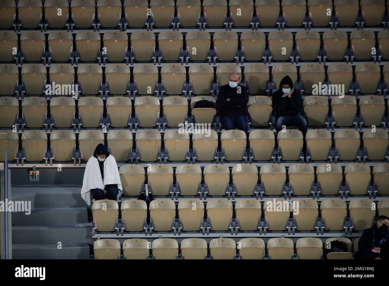 Spectators watch a first round match of the French Open tennis ...