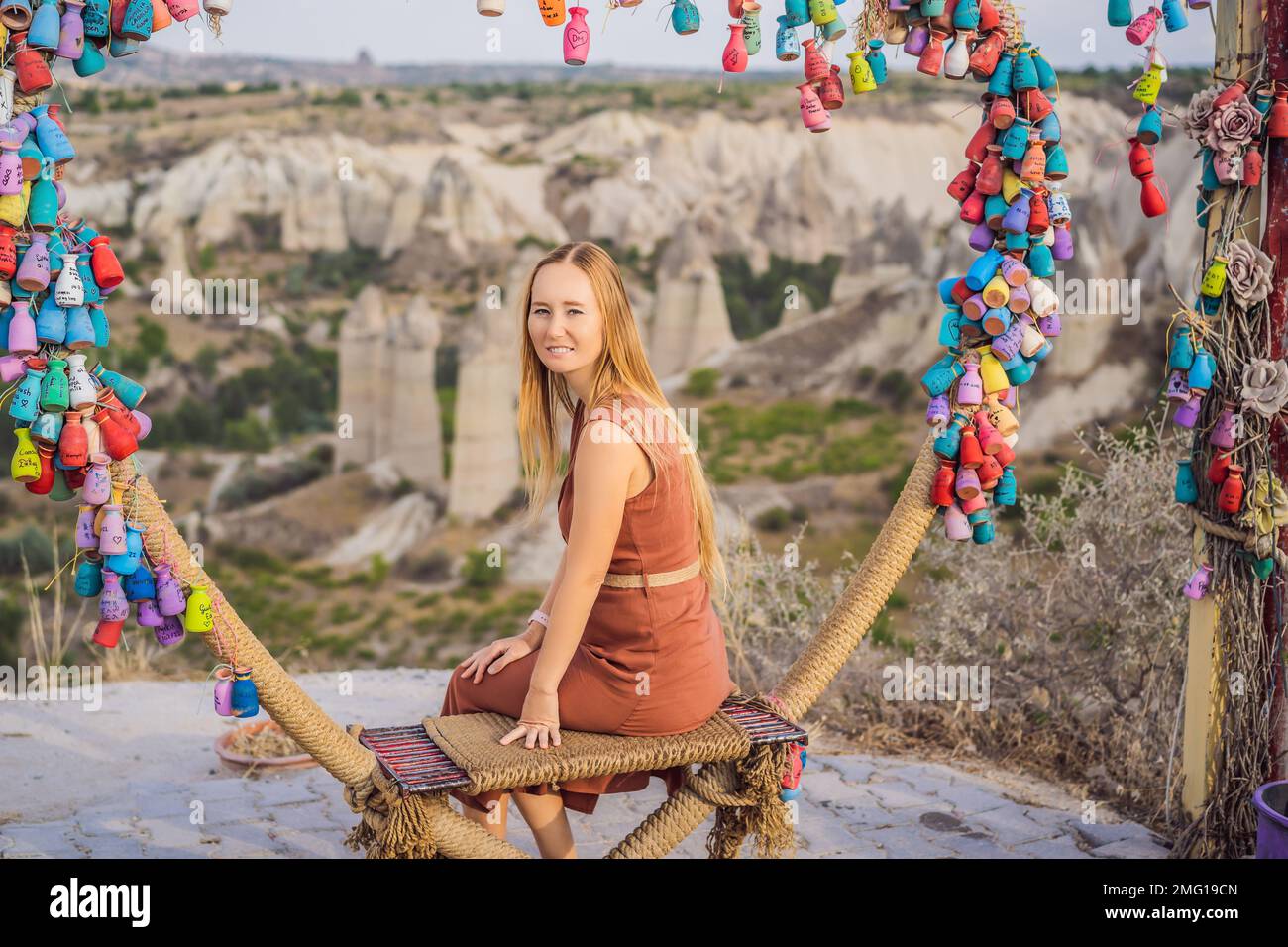 Young woman exploring valley with rock formations and fairy caves near ...
