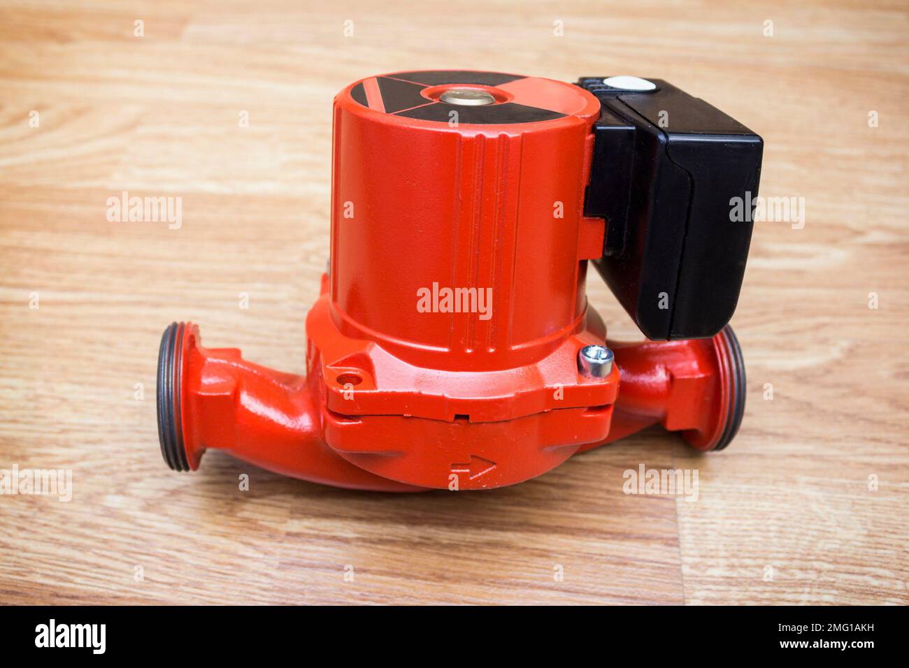 Red circulation steel pump for heating system lies on the floor Stock ...
