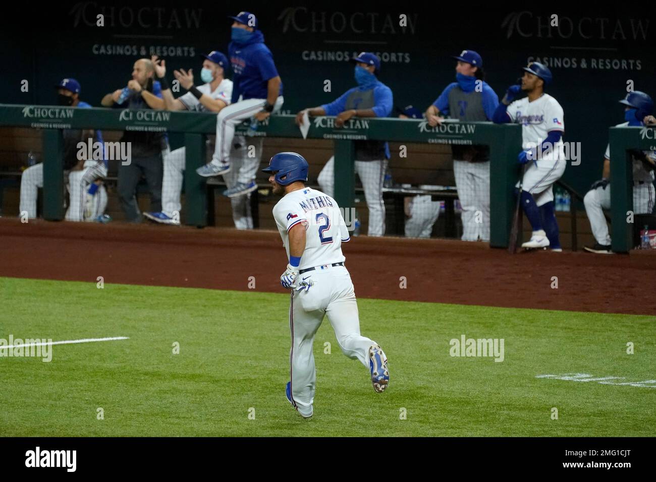Texas Rangers' Jeff Mathis, front, runs up the first base line as he ...