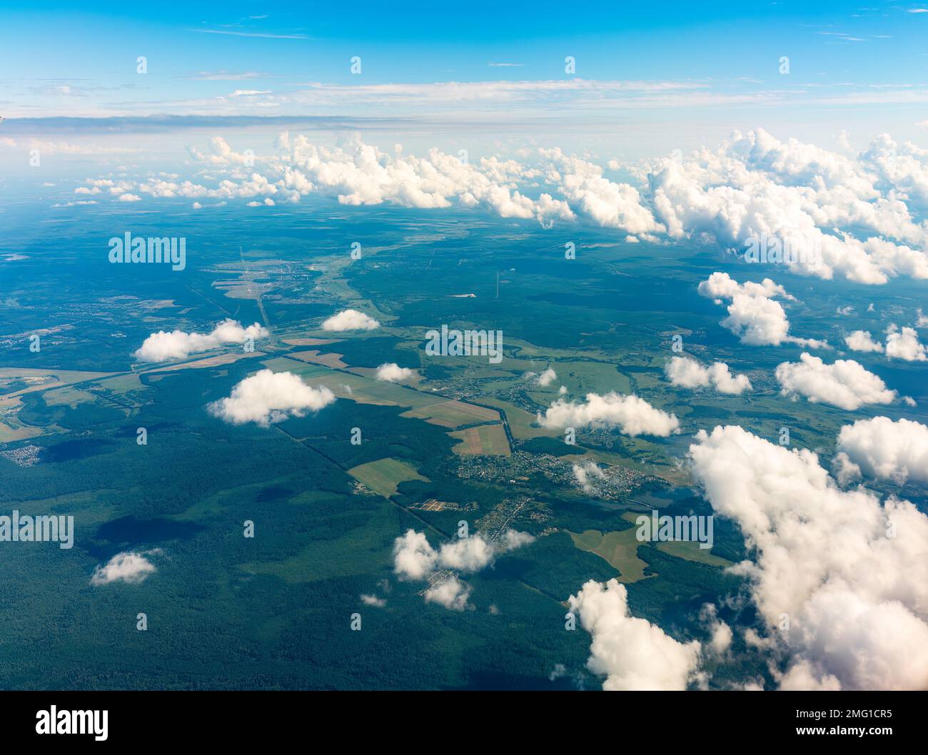 Aerial view from airplane window above green ground. View from the ...