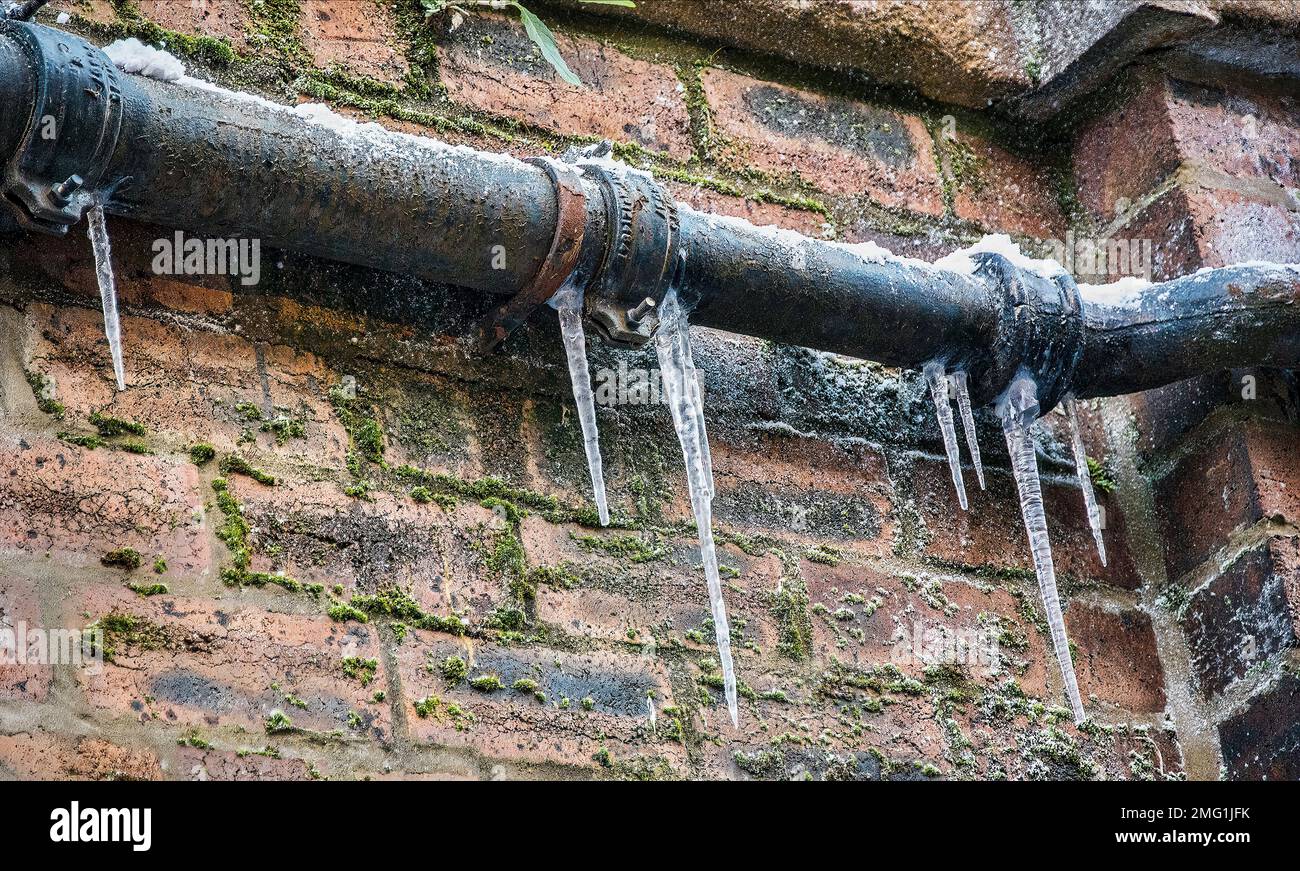 Icicles form on drainpipe in cold winter weather Stock Photo - Alamy