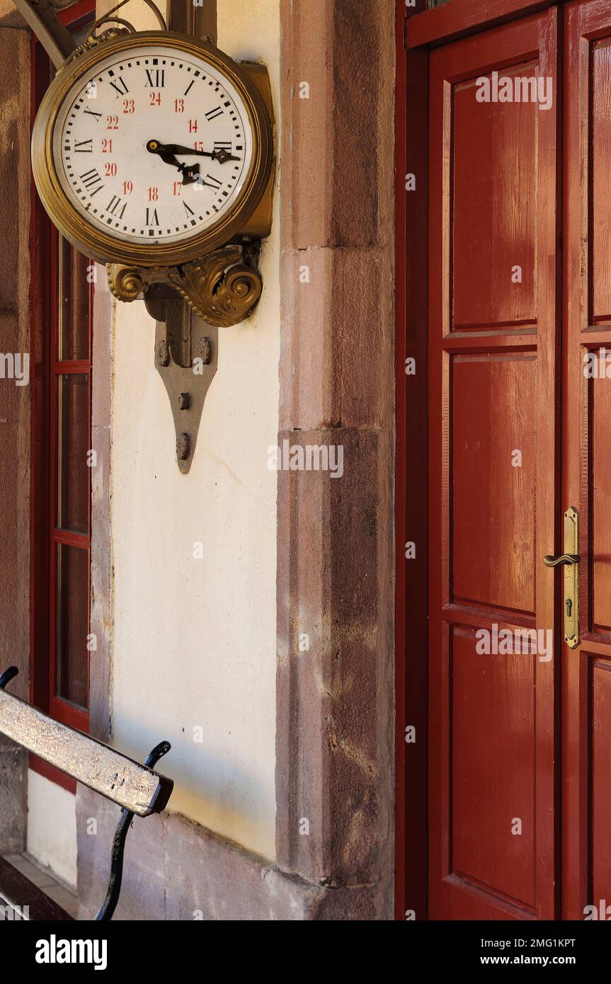 Close-up ancient clock on the door of the old train station in the town ...