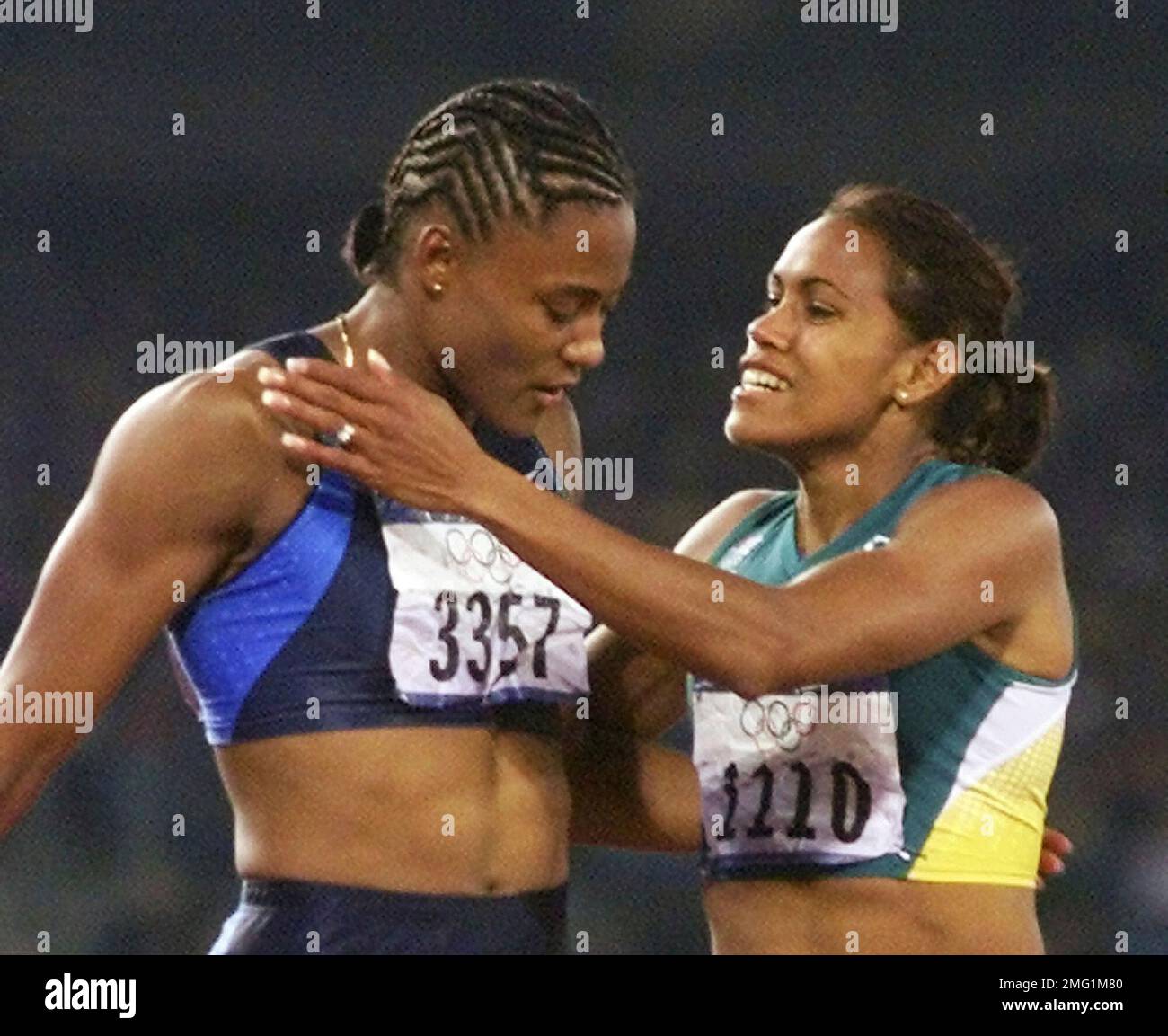 Australia's Cathy Freeman, right, hugs U.S. sprinter Marion Jones, left ...
