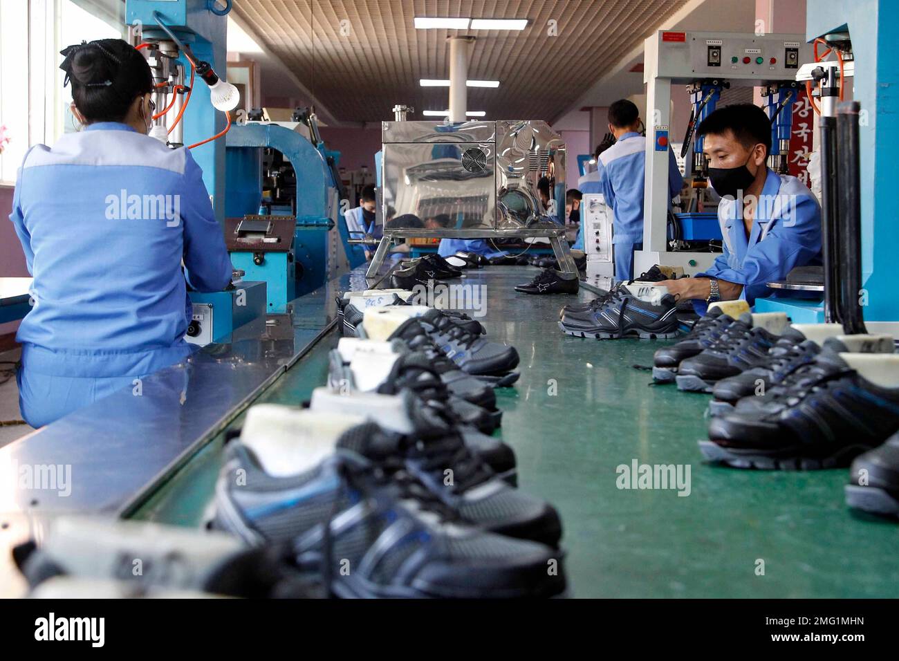 Workers of the Ryuwon Footwear Factory produce various types of "Ryuwon ...