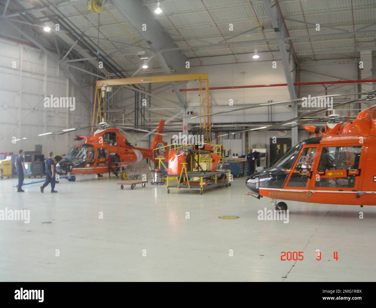 Aircrafts - HH-65 Dolphin - 26-HK-54-53. HH-65s and personnel in hangar ...