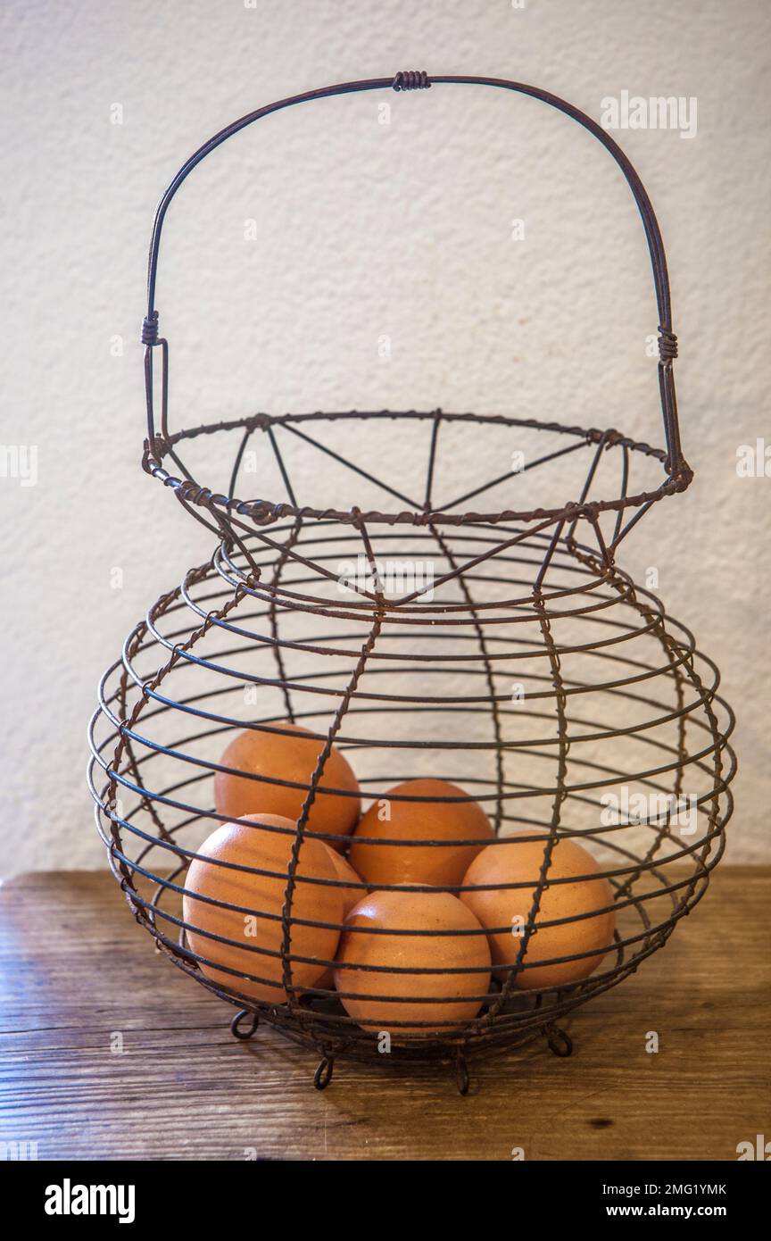 Old rusty wire egg cup. Country style background. Focus on wire Stock ...