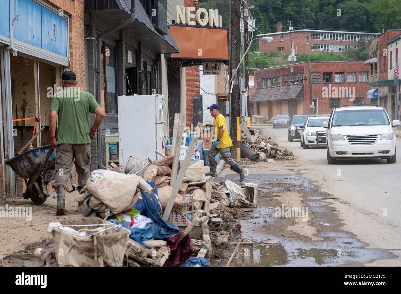 Volunteers working to clean damage and debris left behind after late ...
