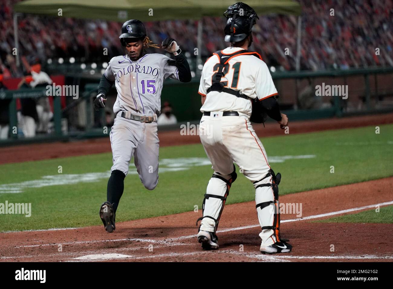 Colorado Rockies' Raimel Tapia, left, runs home to score past San ...