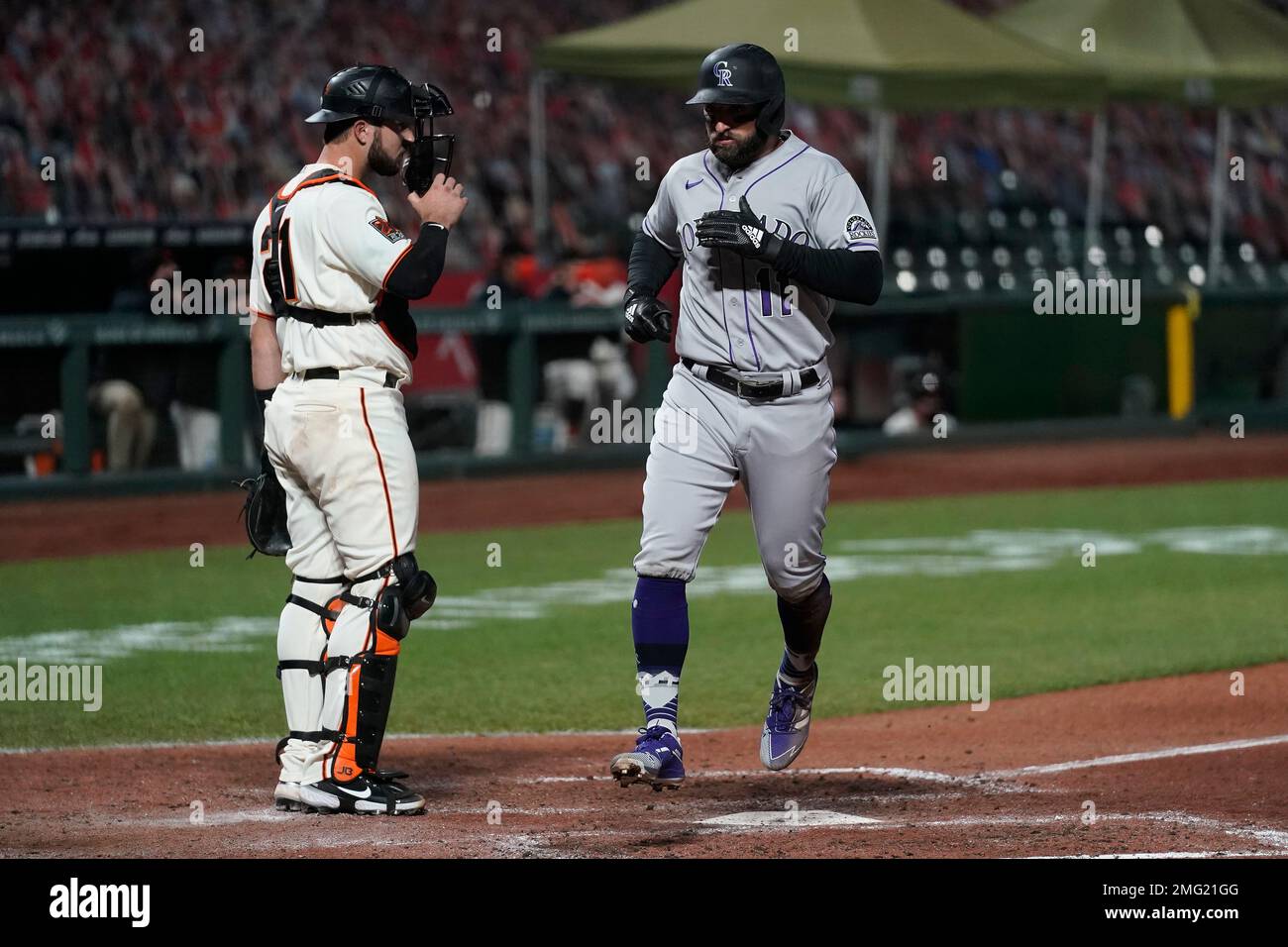 Colorado Rockies' Kevin Pillar, right, scores a run past San Francisco ...