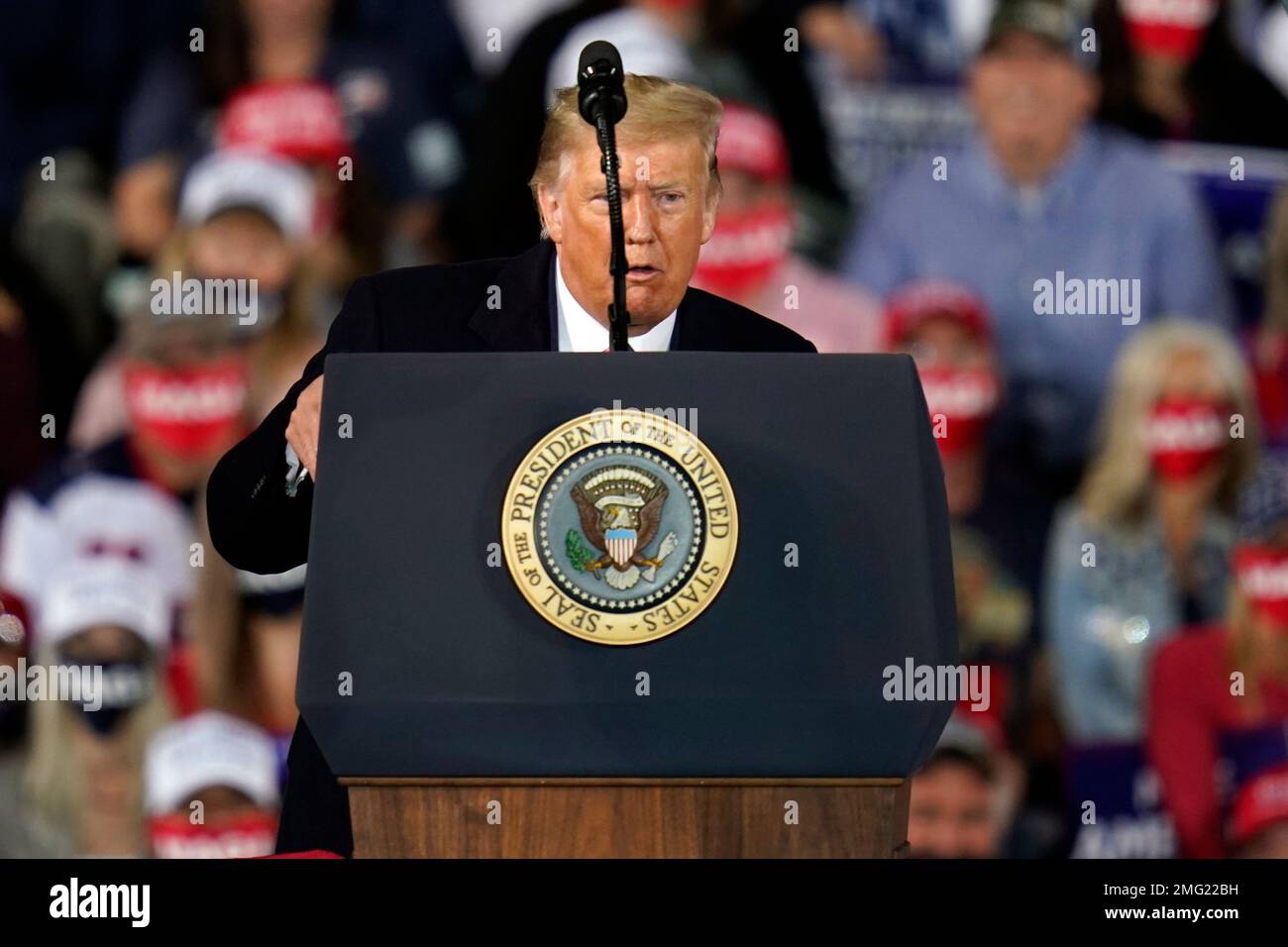 President Donald Trump stoops down as he talks about former New York ...