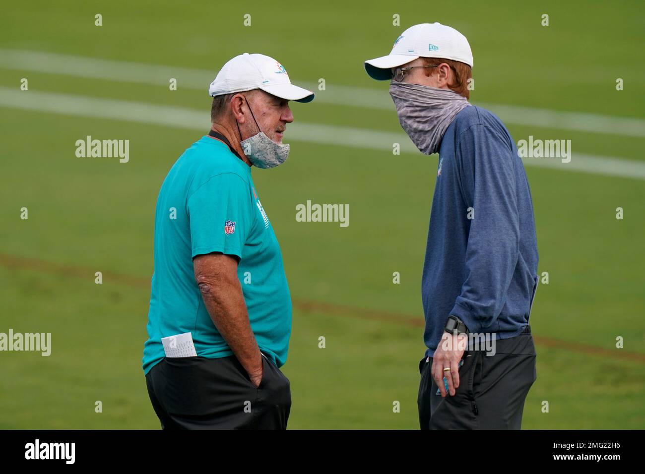 Miami Dolphins offensive coordinator Chan Gailey, left, talks with ...