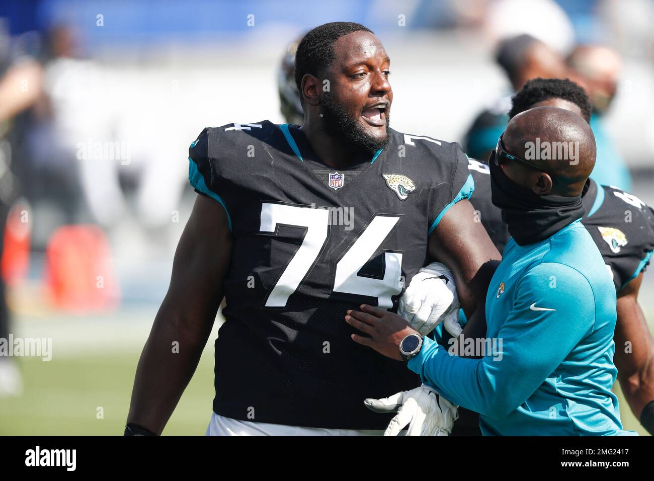 Jacksonville Jaguars offensive tackle Cam Robinson (74) has words with ...