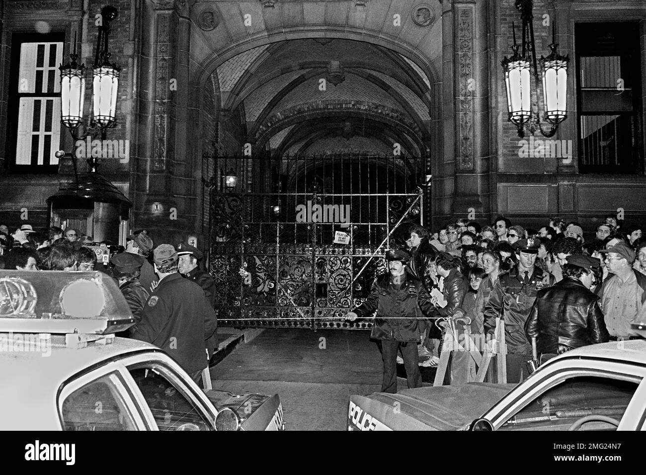 FILE - In this Dec. 9, 1980, file photo, a crowd gathers outside the ...
