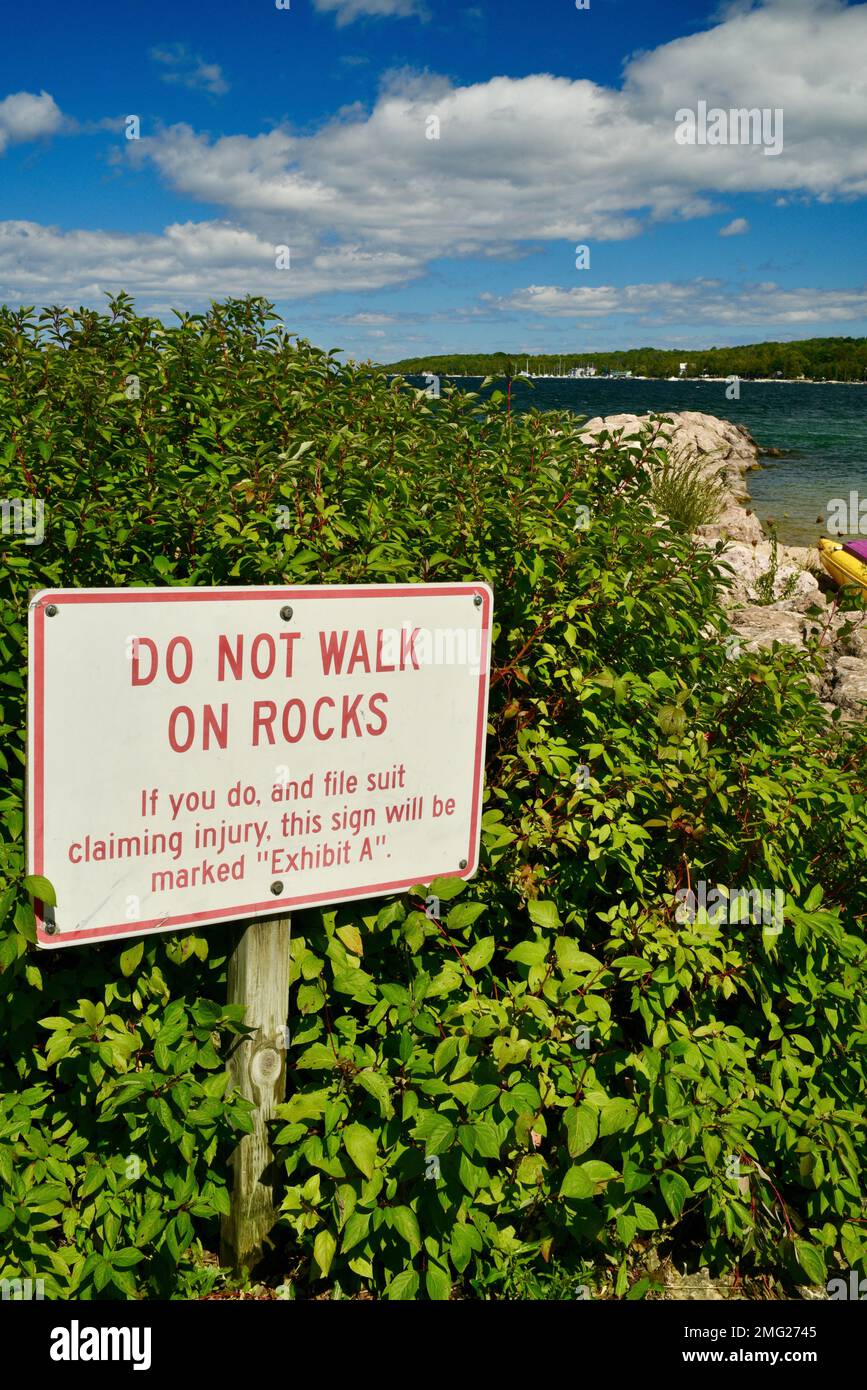 Funny warning "Do Not Walk On Rocks" sign posted at edge of harbor in ...