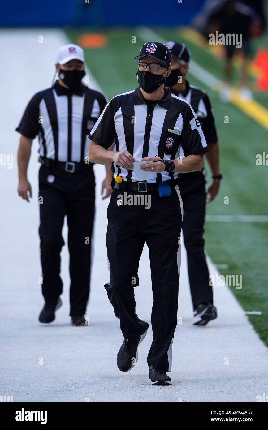 NFL down judge Dana Mckenzie (8) walks around the field before an NFL ...