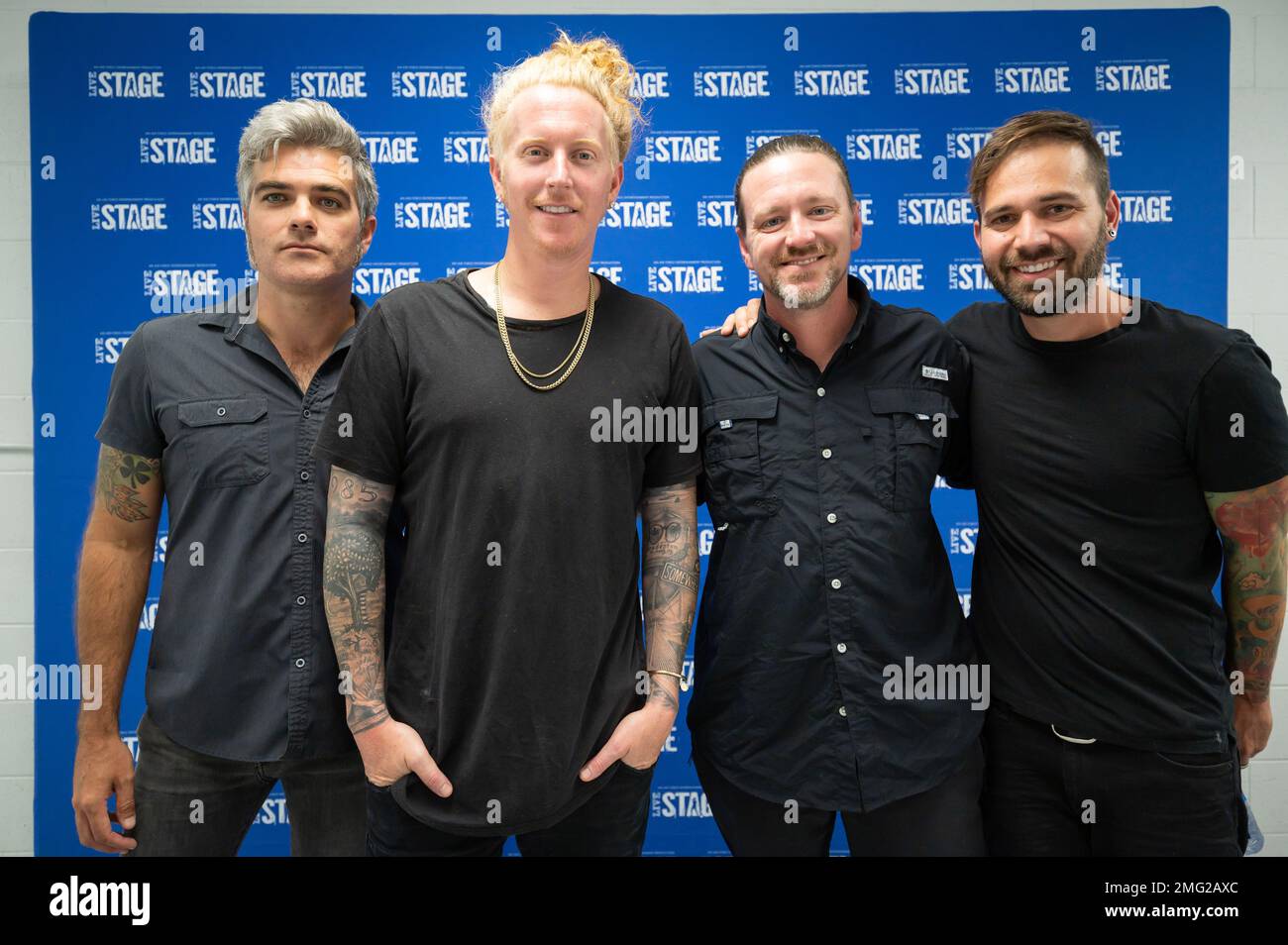 Members of the rock band We the Kings pose for a group photo before ...