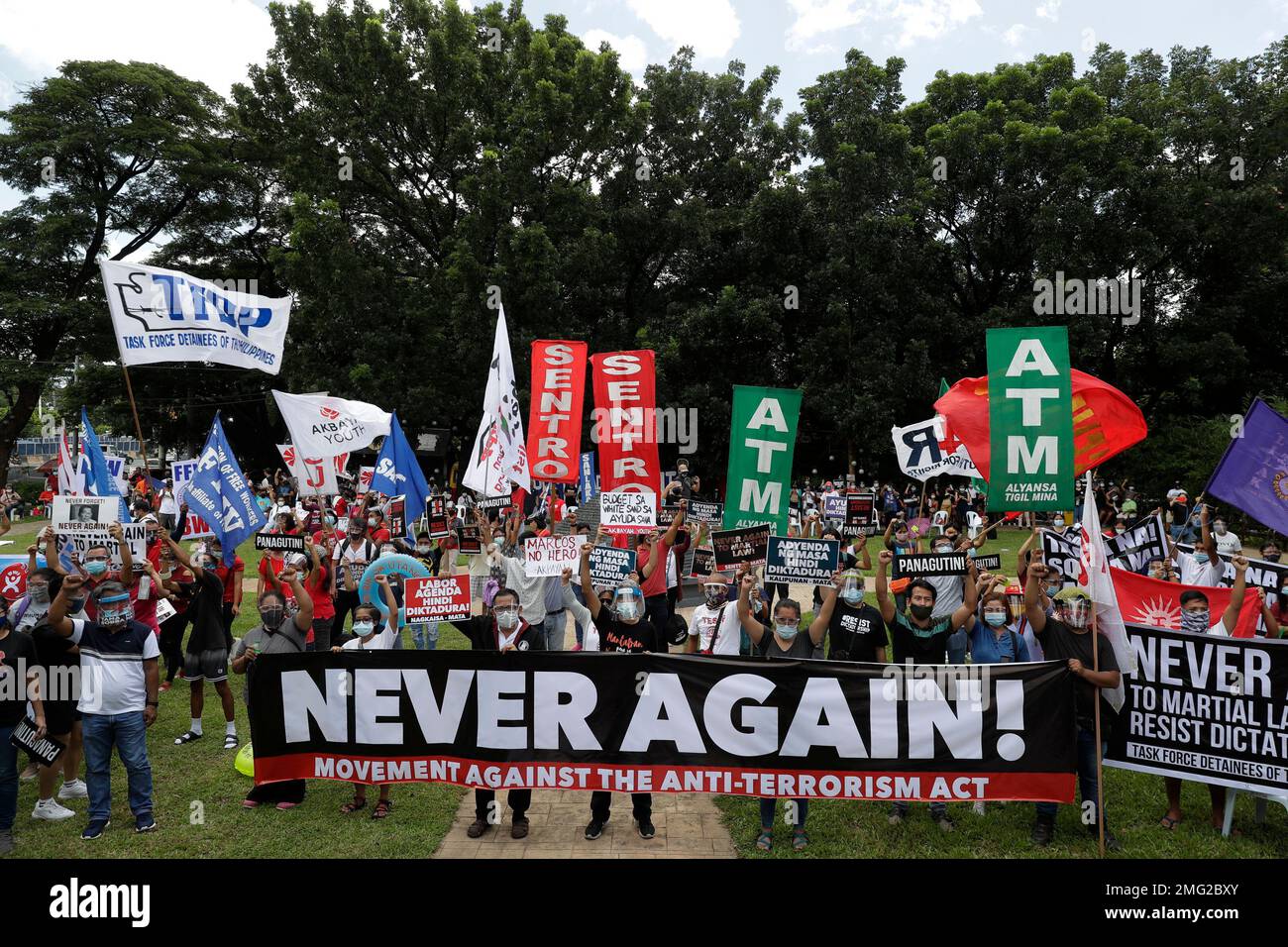 Protesters hold slogans during a rally to mark the 48th anniversary of ...