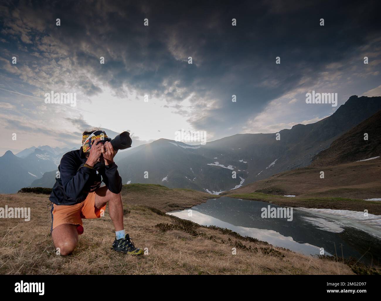 Photographer shooting the landscape Stock Photo - Alamy